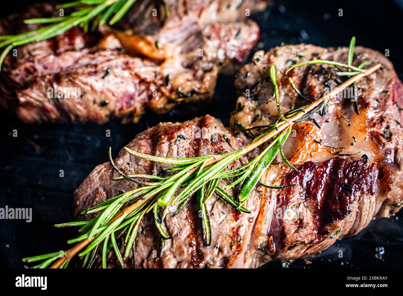 Marbled beef steak with rosemary is grilled. Close-up. High quality ...