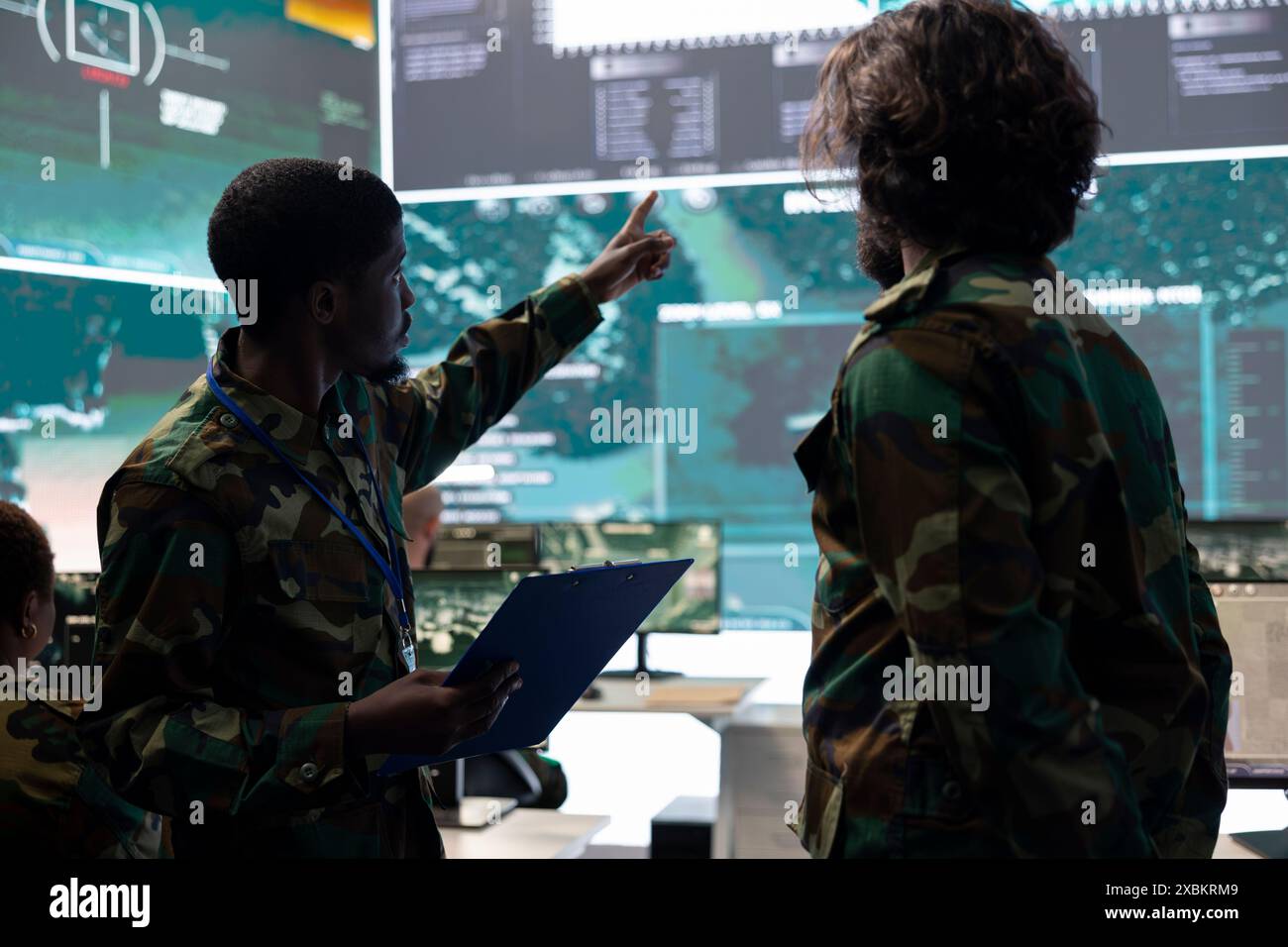 Servicemen working on new national safety plan for an operation, studying the CCTV surveillance ...