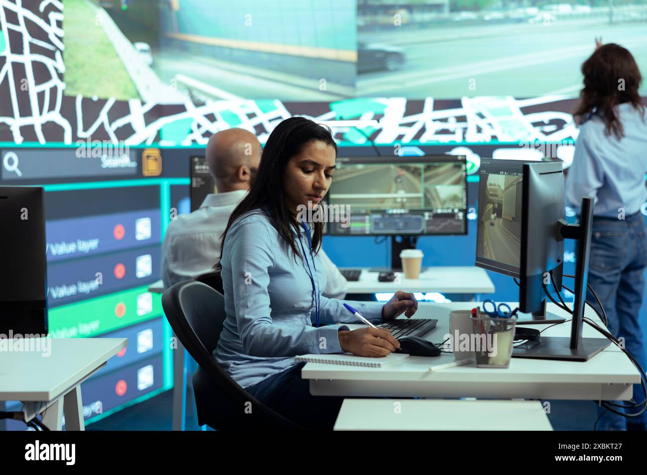 Indian woman employee locating delivery truck drivers via satellite map ...