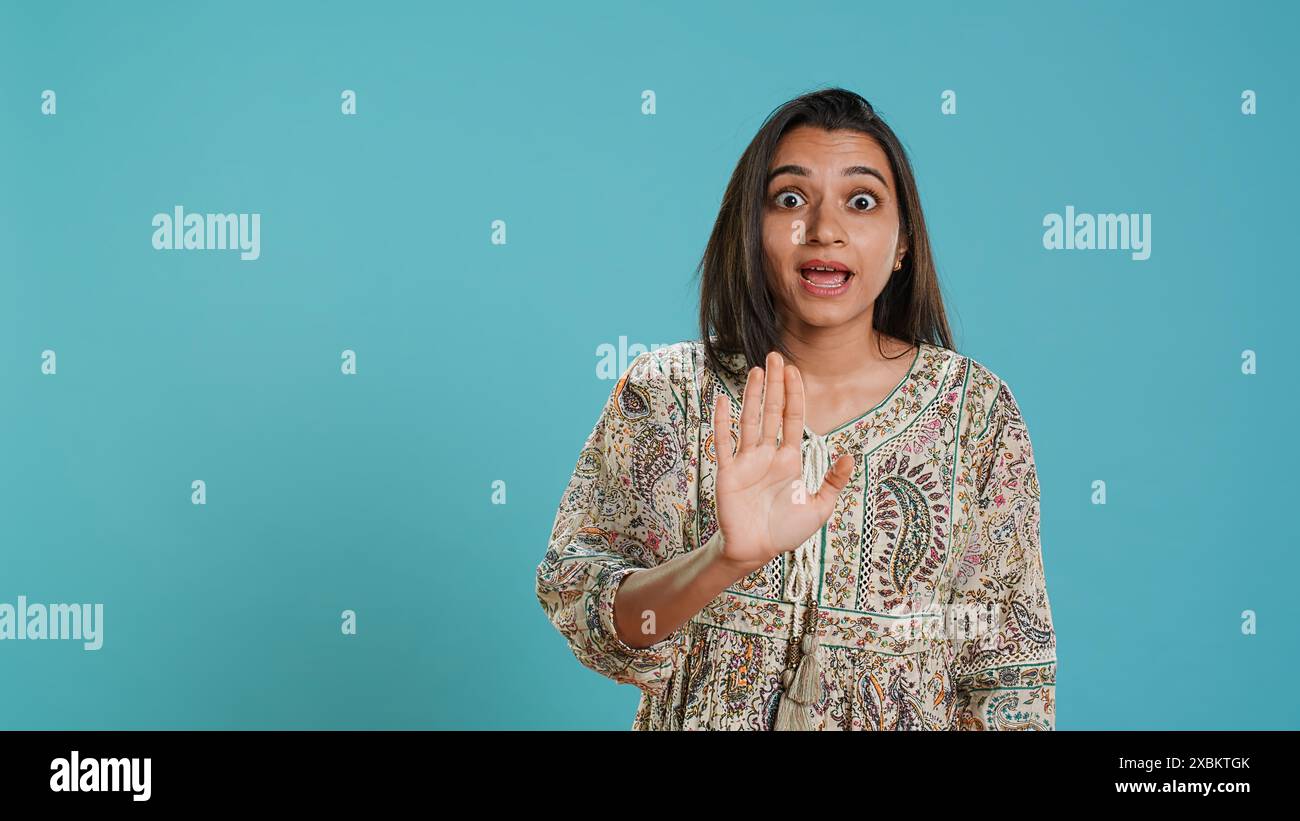 Stern indian woman doing stop hand gesture sign, complaining ...
