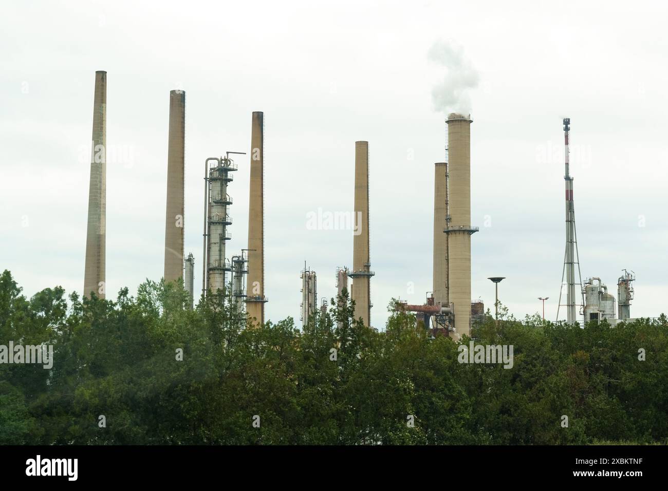 A factory emitting large amounts of thick, dark smoke into the ...