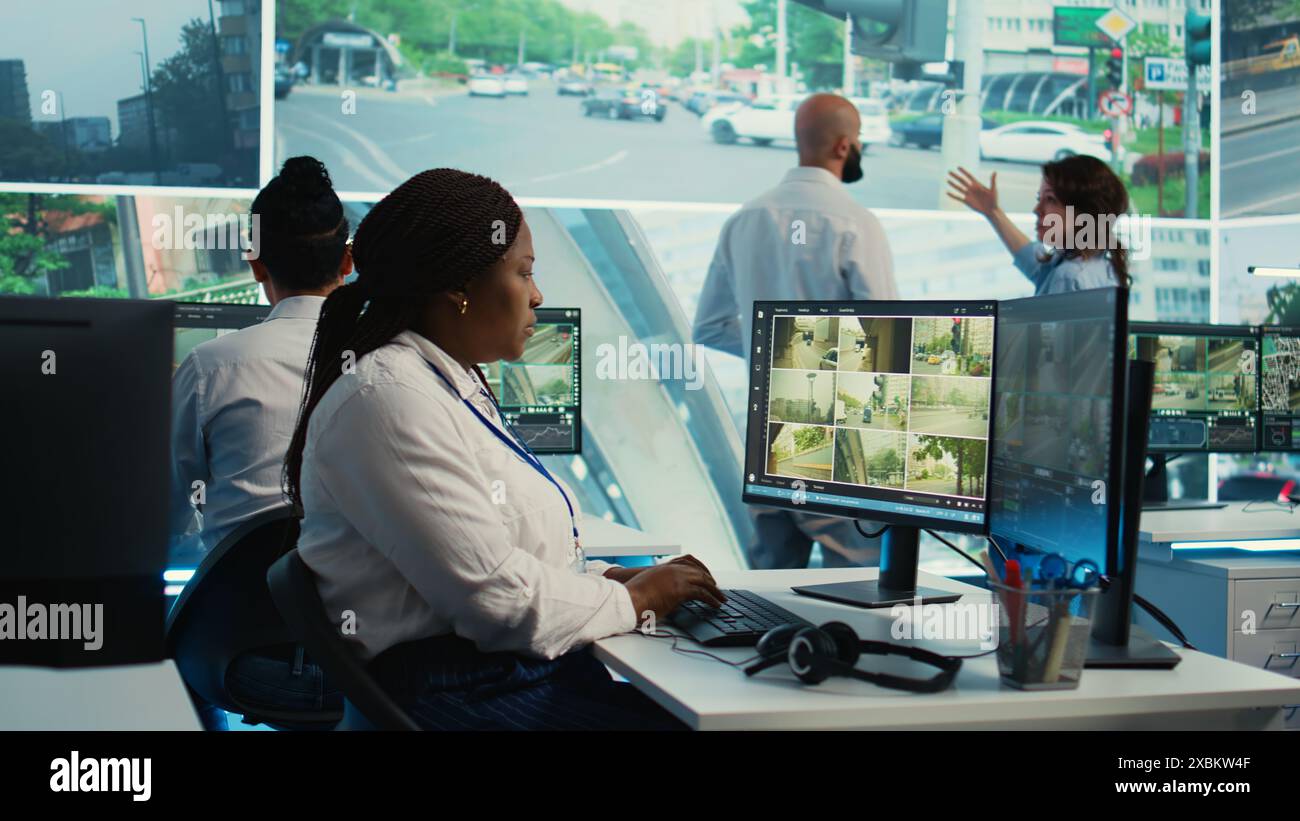 African american employee gathers data on cars in traffic through red ...