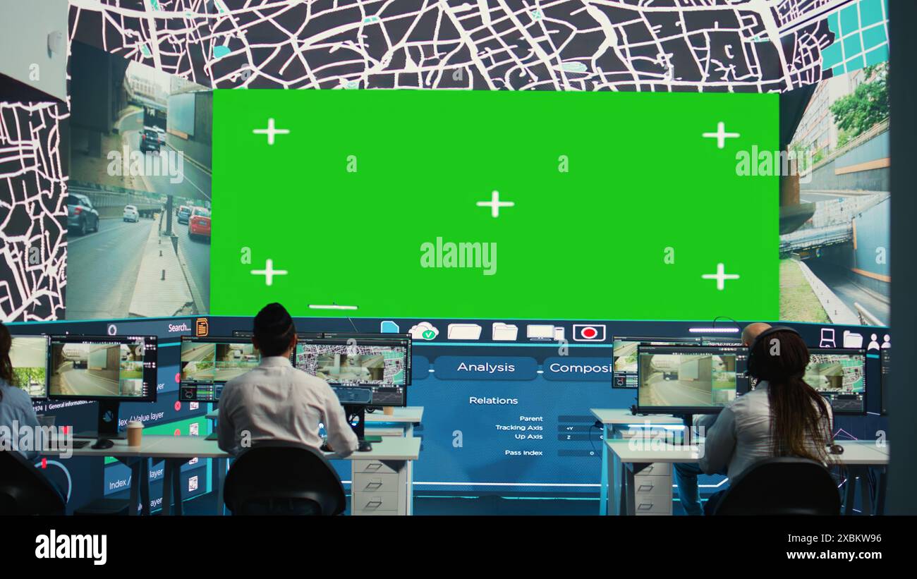 Shipping agency workers examine satellite map with huge greenscreen ...