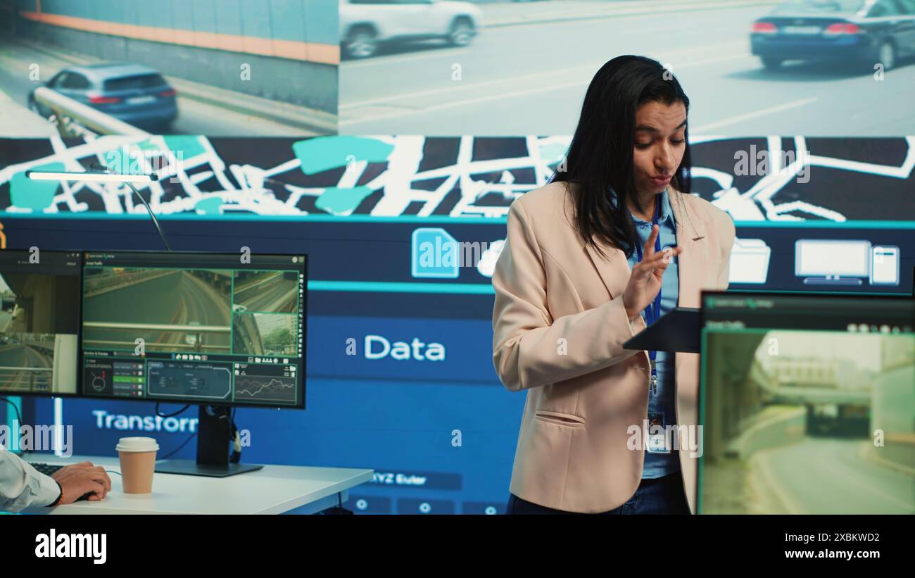 Indian manager and her team monitoring their delivery cars in traffic ...