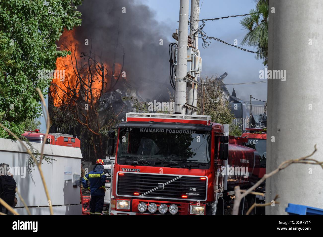 Athens, Greece. 12 June 2024. Flames and black smoke rise into the sky ...