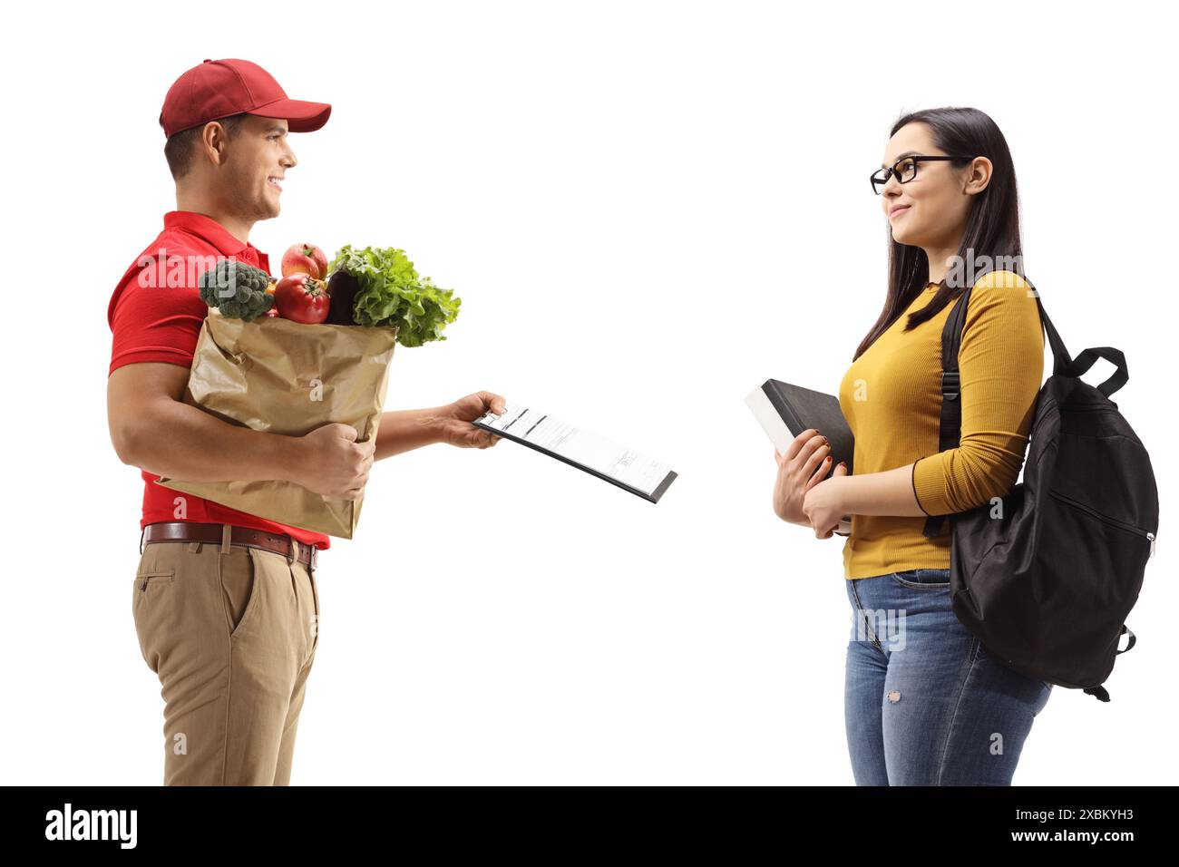 Delivery man holding groceries in a paper bag and giving a document to ...