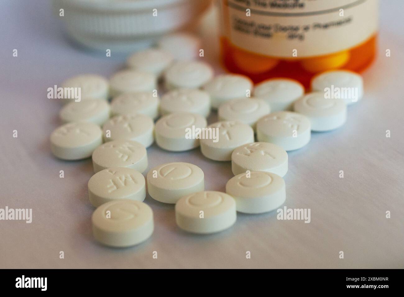 Generic metformin dispensed from a pharmacy 500 mg tablets on a white ...