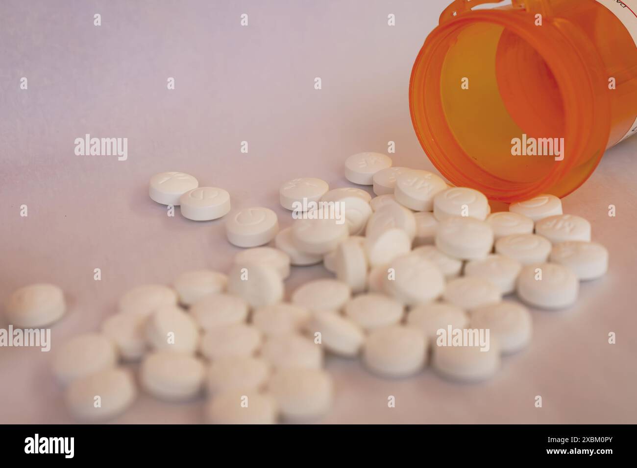 Generic metformin dispensed from a pharmacy 500 mg tablets on a white ...