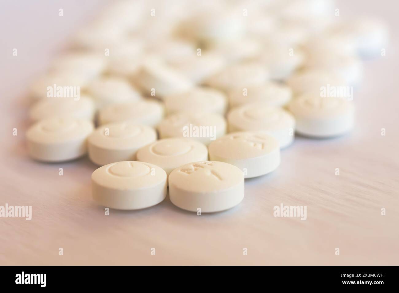 Generic metformin dispensed from a pharmacy 500 mg tablets on a white ...