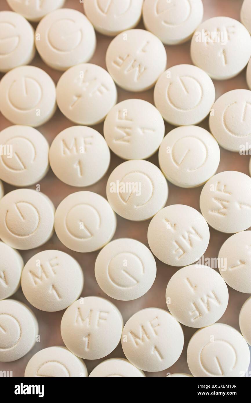 Generic metformin dispensed from a pharmacy 500 mg tablets on a white ...