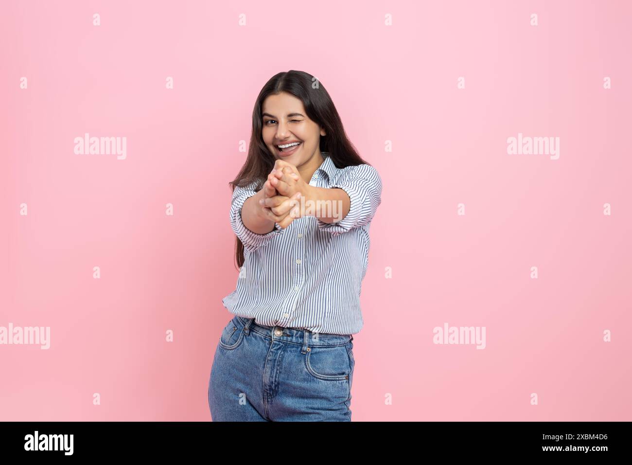Smiling Indian woman showing finger gun Stock Photo - Alamy