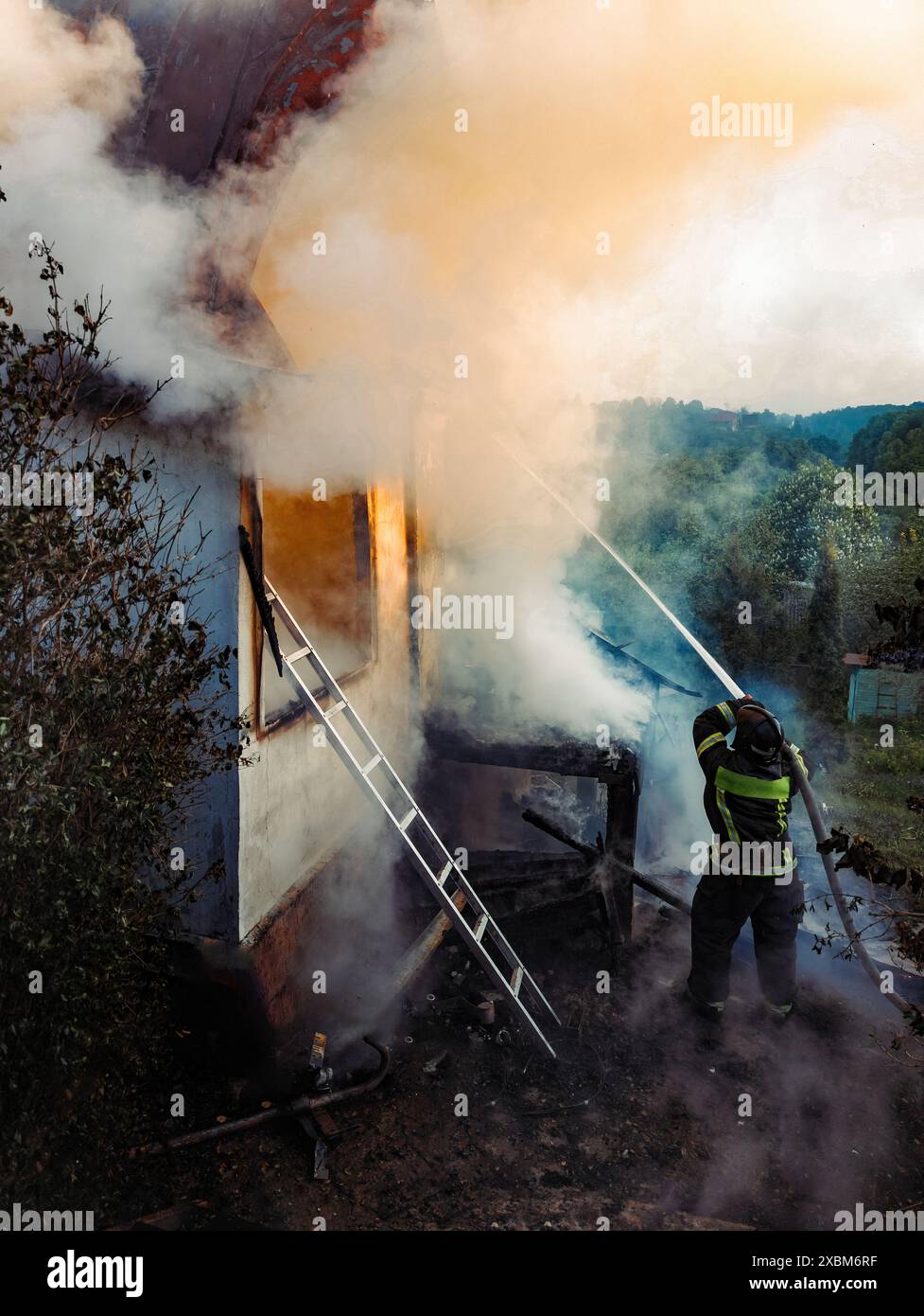 Firefighter extinguish fire in house using spraying hose Stock Photo ...