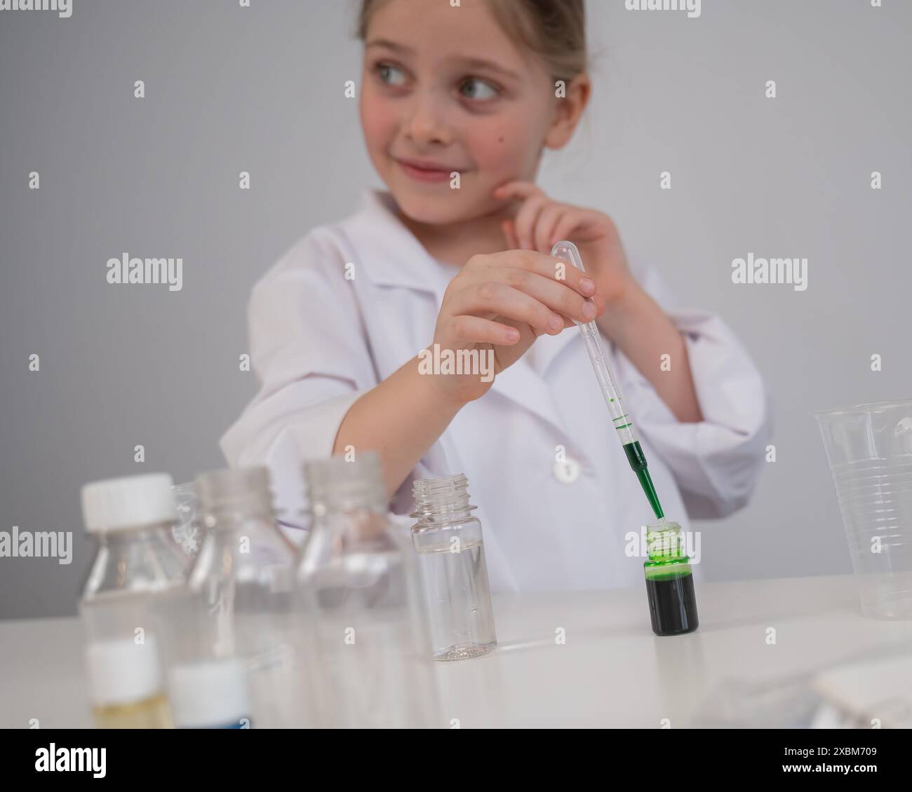 Caucasian girl doing chemical experiments on a white background Stock ...
