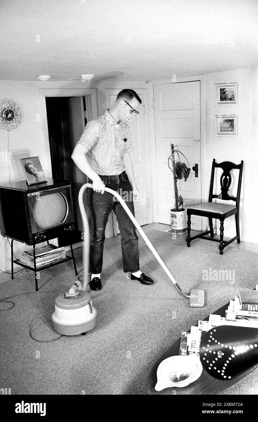 Charles Cline, married student at University of Illinois, vacuuming his ...