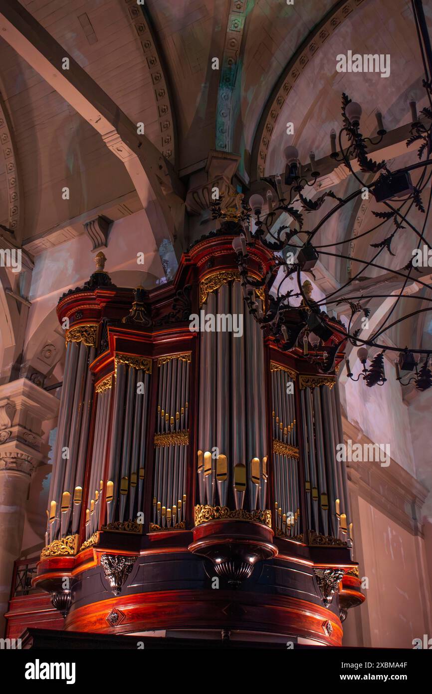 Large organ in a Noorderkerk church, ornately decorated with golden ...