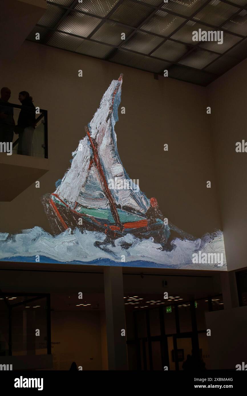 A sailing ship is artistically projected onto an interior wall in the ...