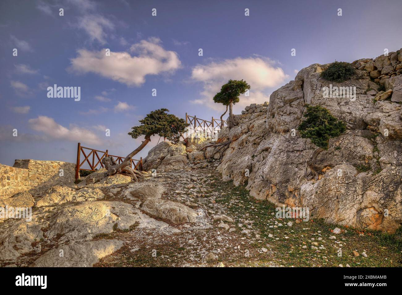 HDR, Rocky landscape with stony path, wooden fence and scattered trees ...