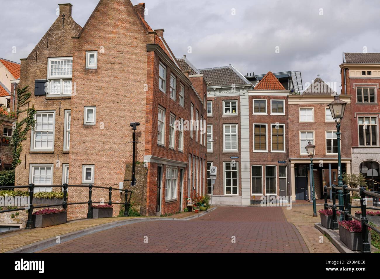 Cobbled streets lined with brick houses with historic facades and ...