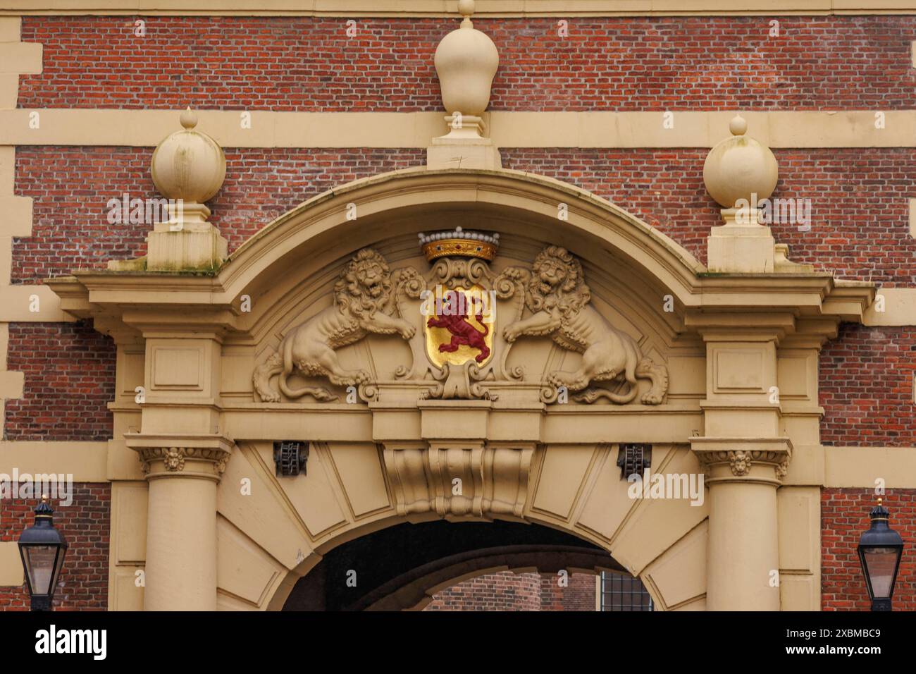 A historic gate with decorative stone reliefs of two lions flanking a ...