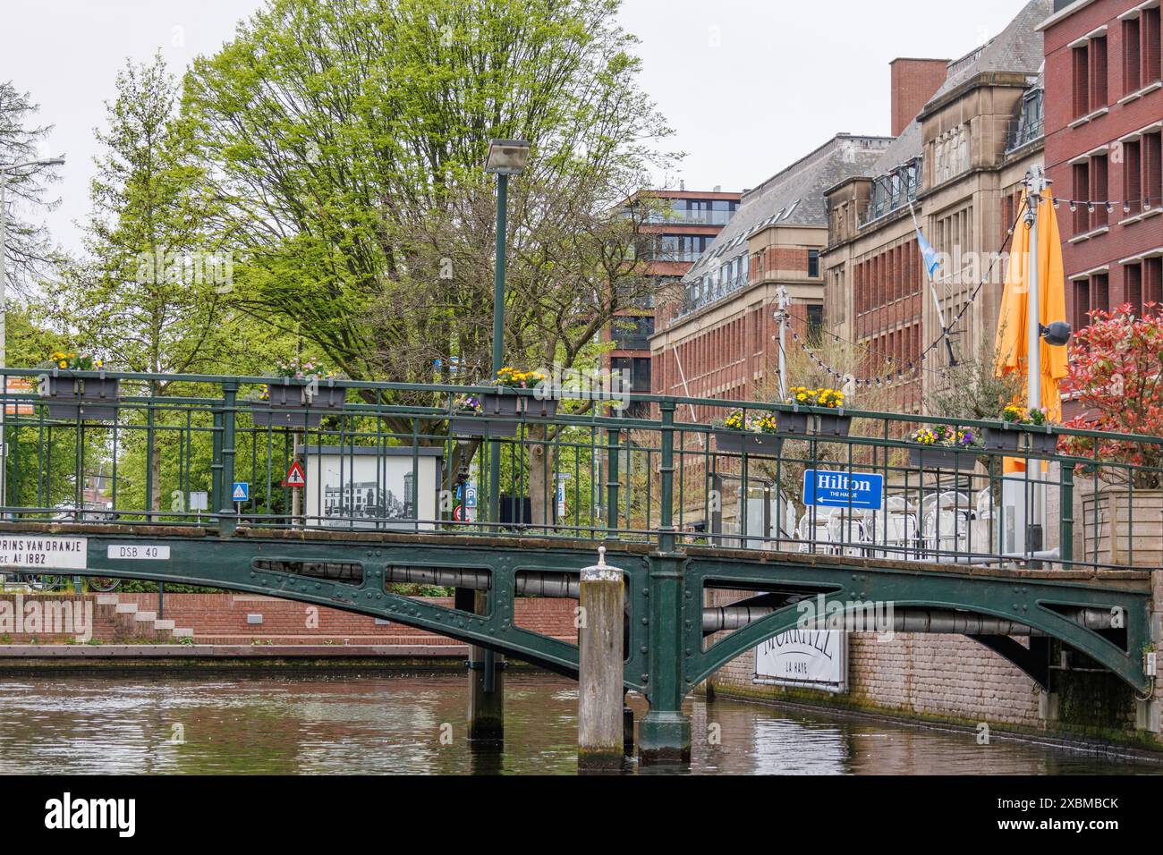 Urban scene with a bridge over a canal, surrounded by modern and old ...