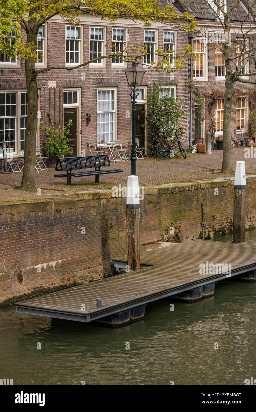 Picturesque canal-side scene with historic brick houses and a quiet ...