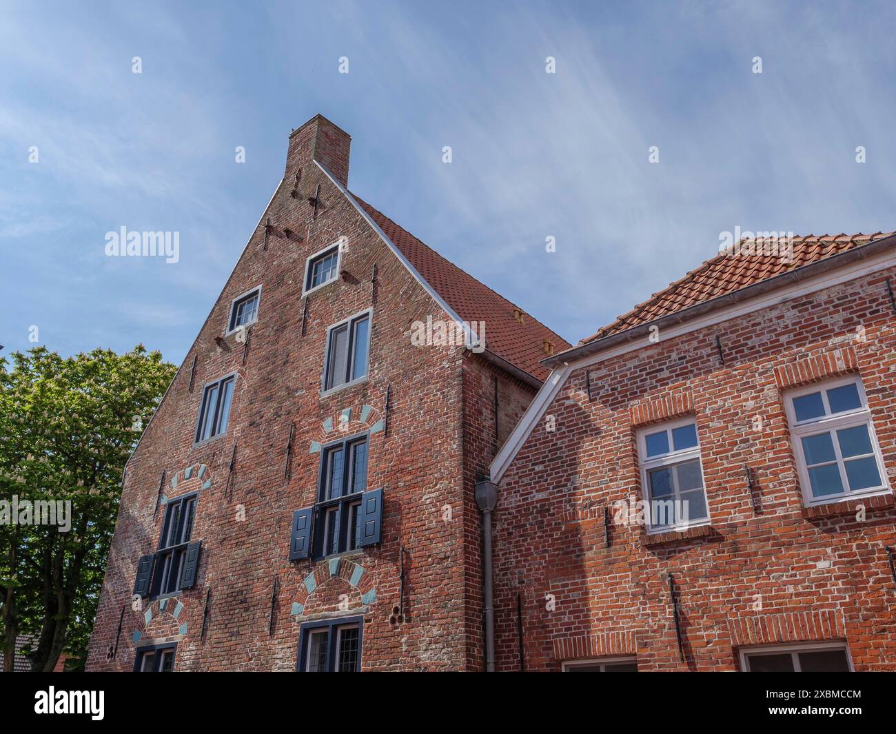 Historic brick houses with typical North German architecture under a ...