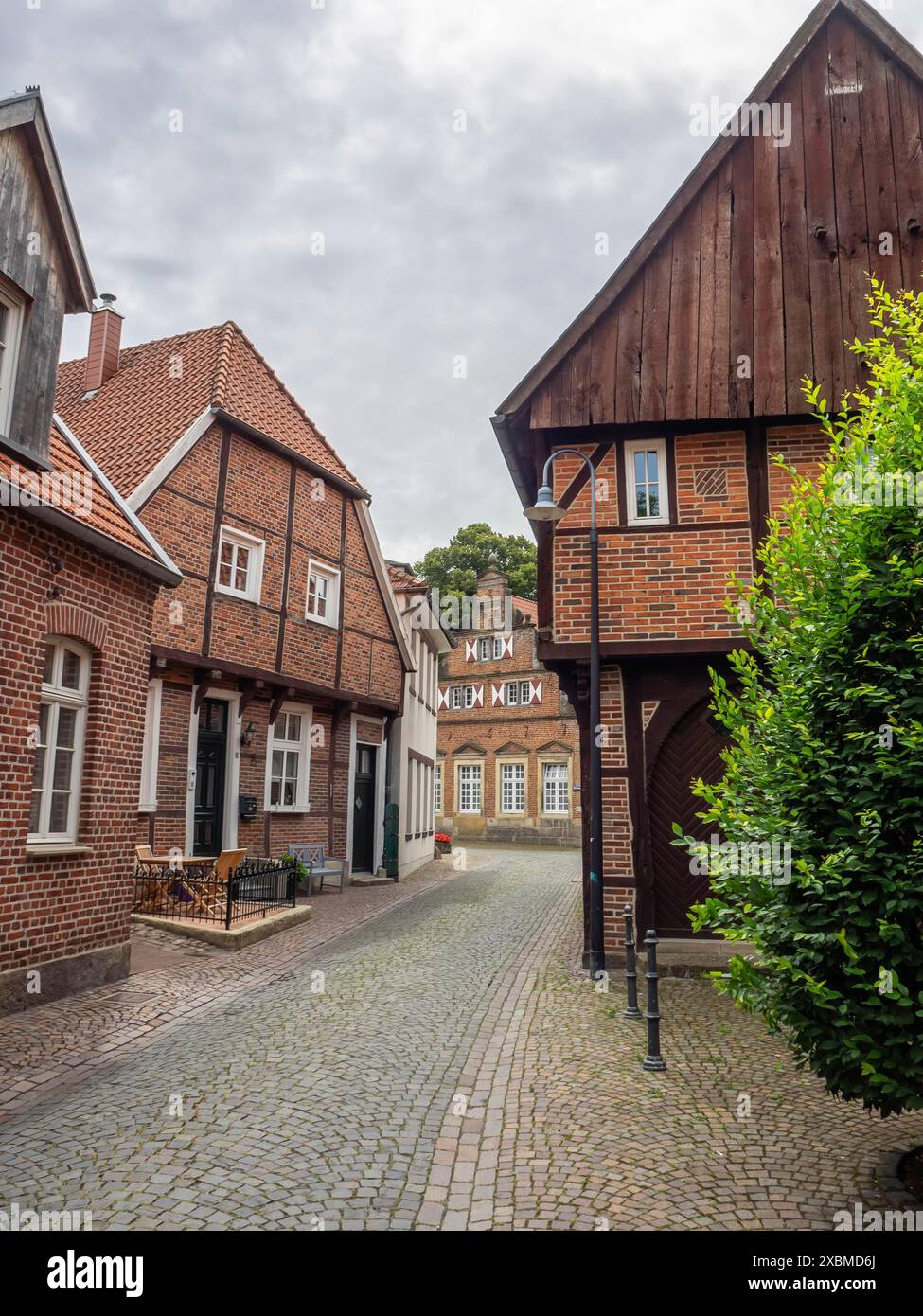 Cobbled village street with old half-timbered houses and brick ...