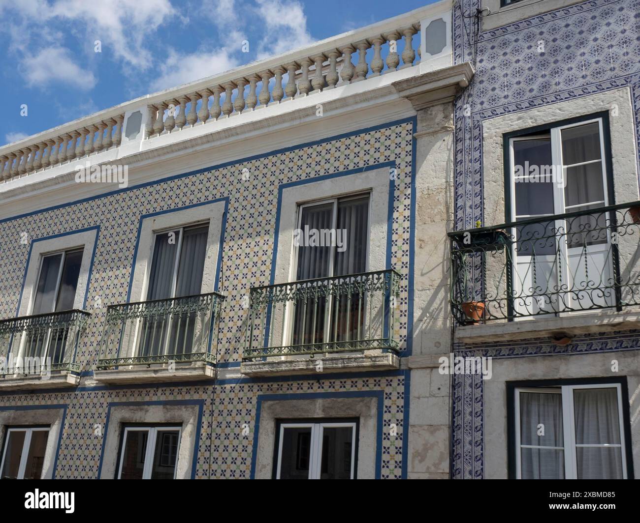 Traditional Portuguese building facade with blue azulejos and balconies ...