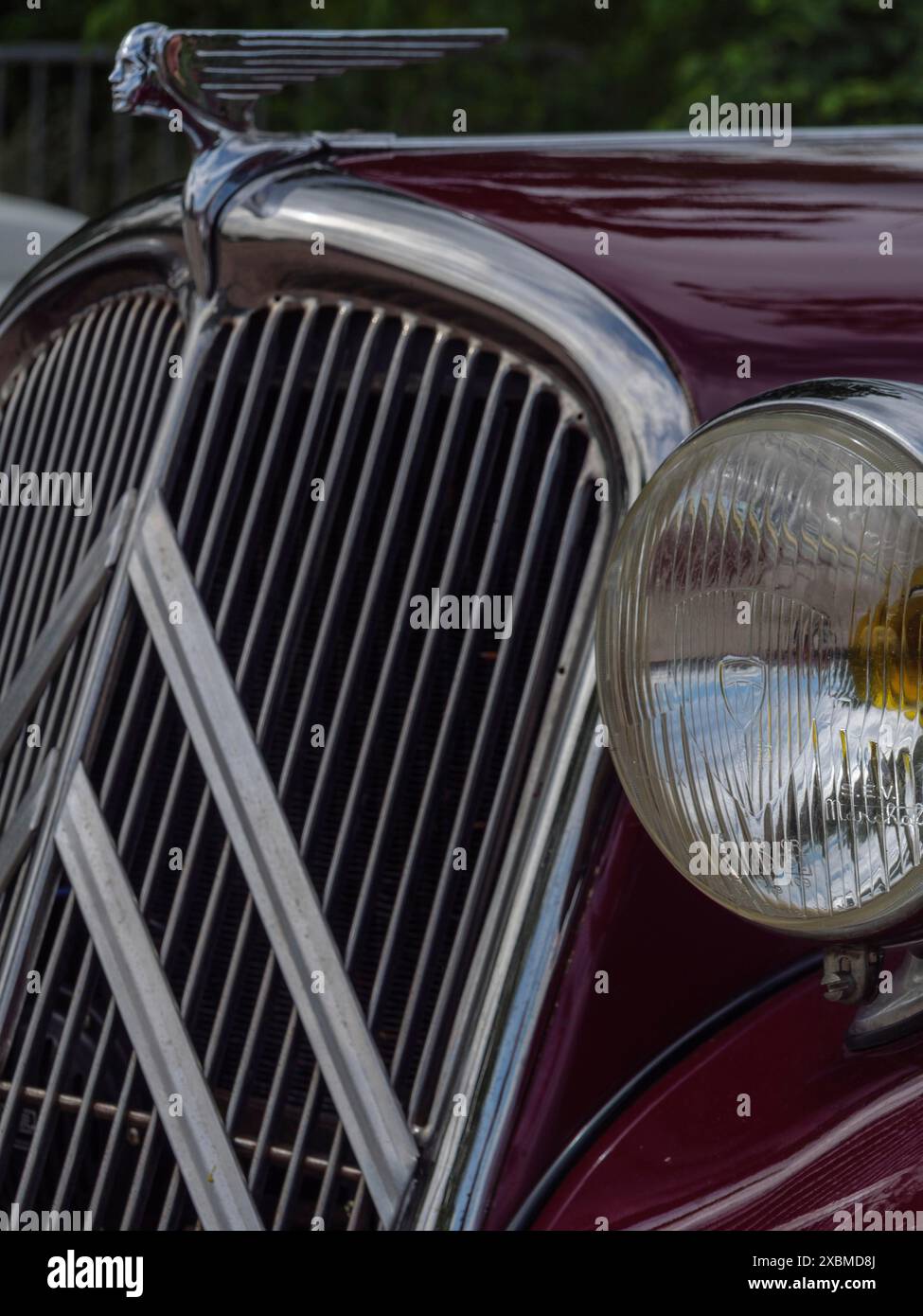 Front view of a red vintage car with striking radiator grille and ...