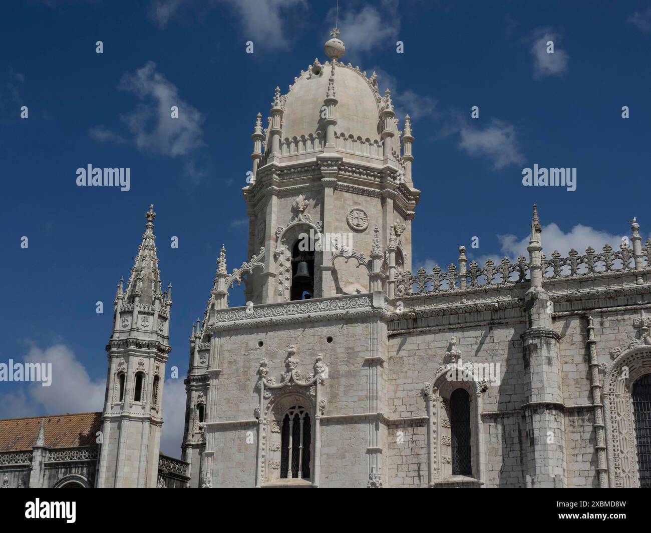 Large Gothic church facade with several towers and decorations under a ...