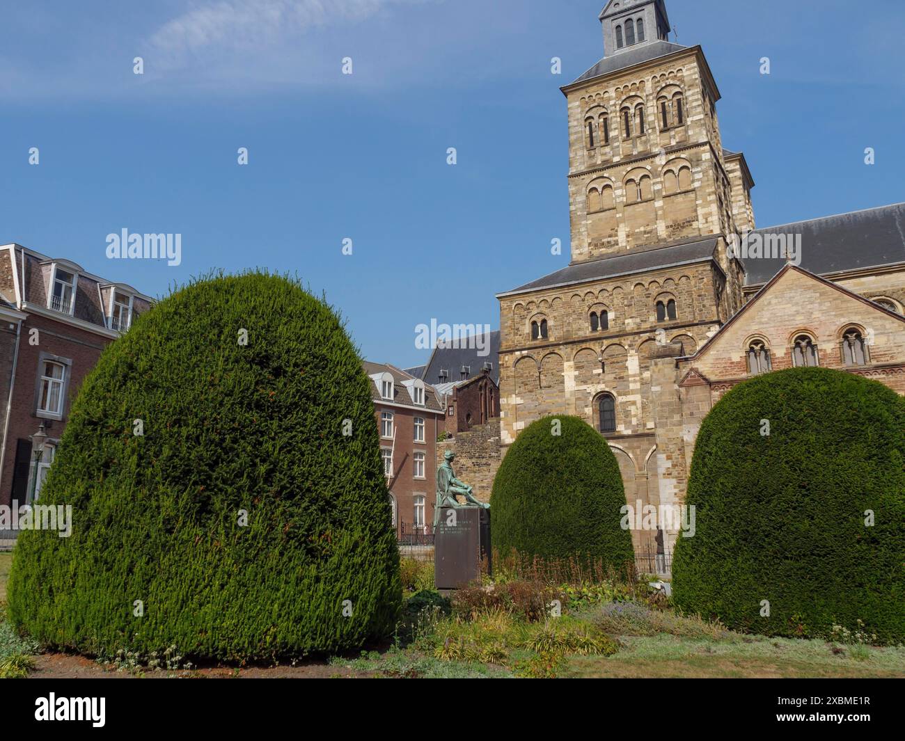 An attractive garden with well-kept hedges in front of a historic ...