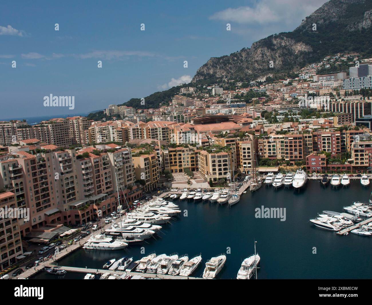 Coastal town with a marina, nestled in a mountainous landscape, monte ...