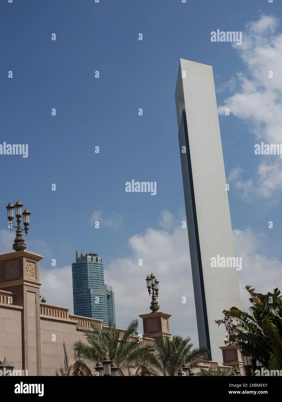 Tall buildings in a modern city under a blue sky with scattered clouds ...