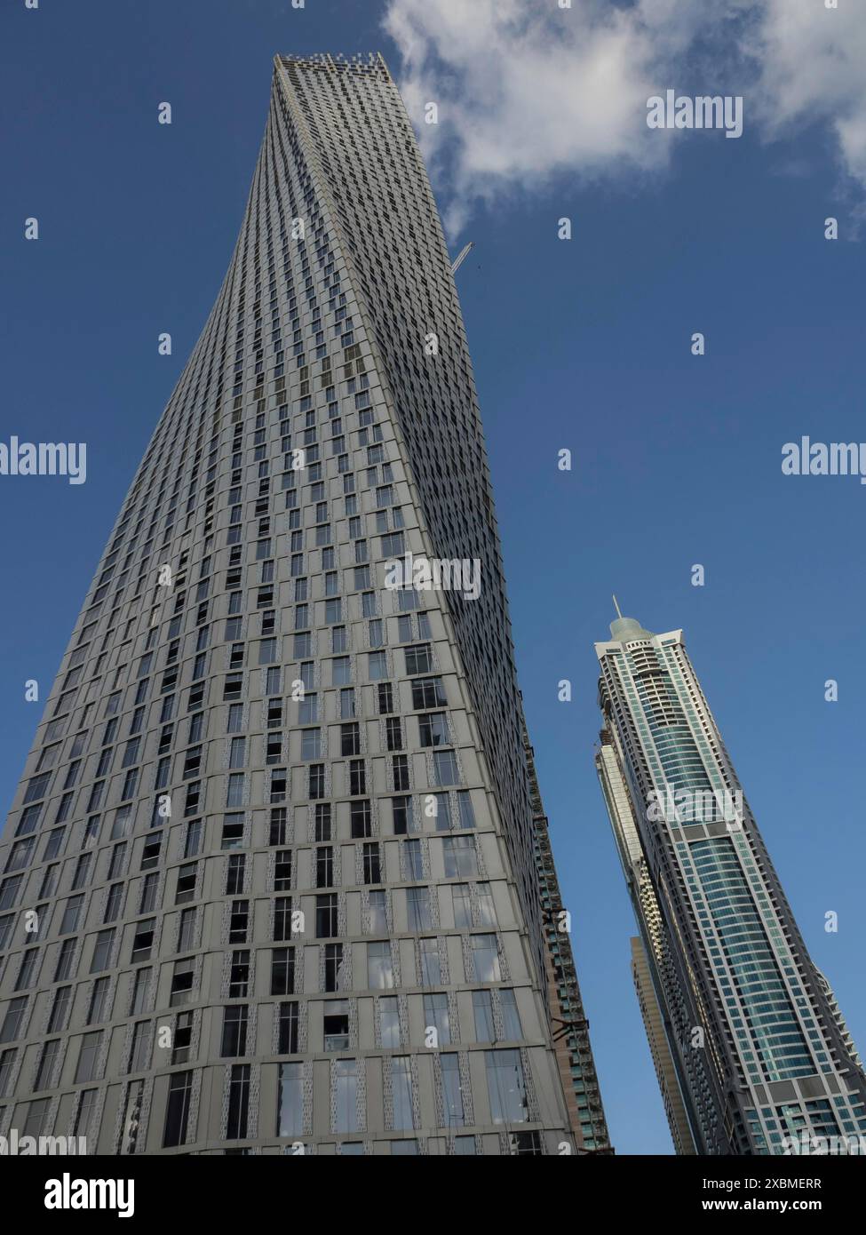 A uniquely twisted skyscraper and another modern building rise into the ...