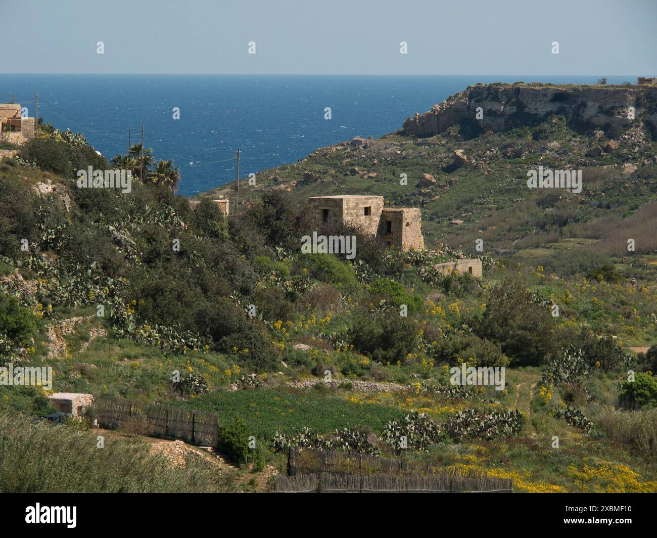 Coastal landscape with rolling hills, old stone houses and views of the ...