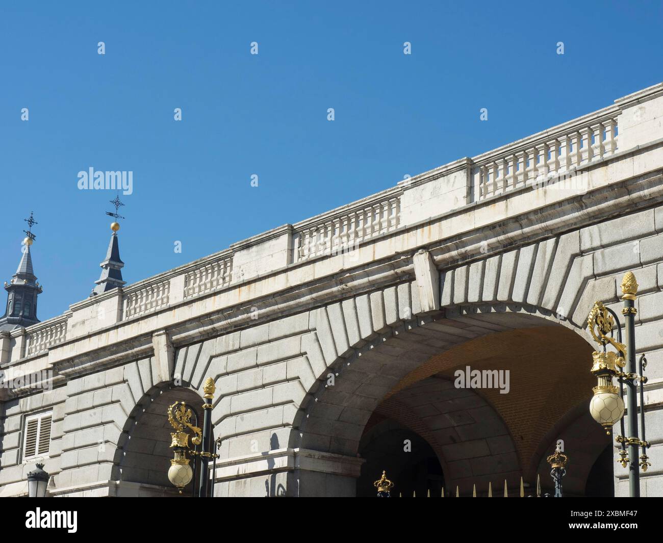 Large arch of a historic building with golden decorations in front of a ...
