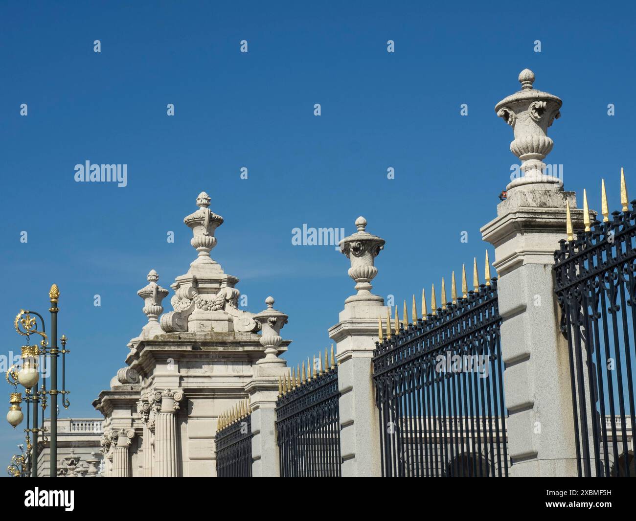 Section of a historic wall with golden decorations and a wrought-iron ...