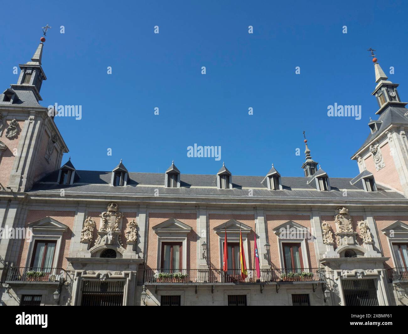 Large historic building with two towers and multiple entrances under a ...