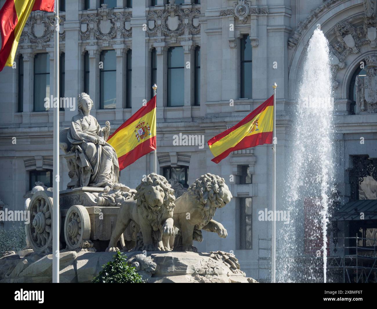A majestic statue with a fountain in the background, flanked by Spanish ...