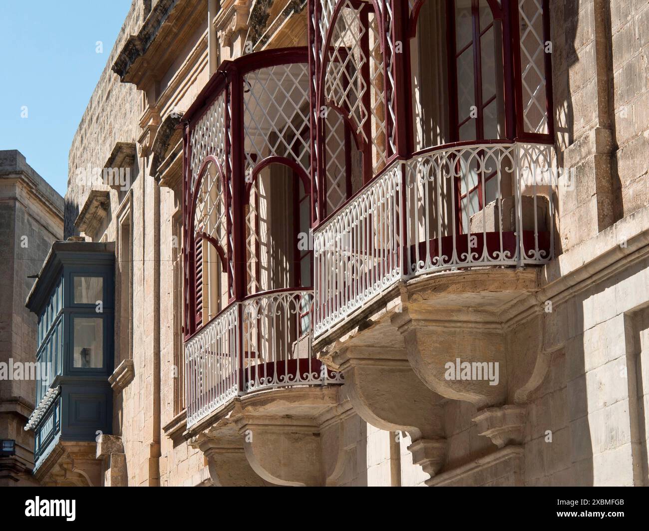Historic balconies with elaborately decorated wrought-iron railings and ...
