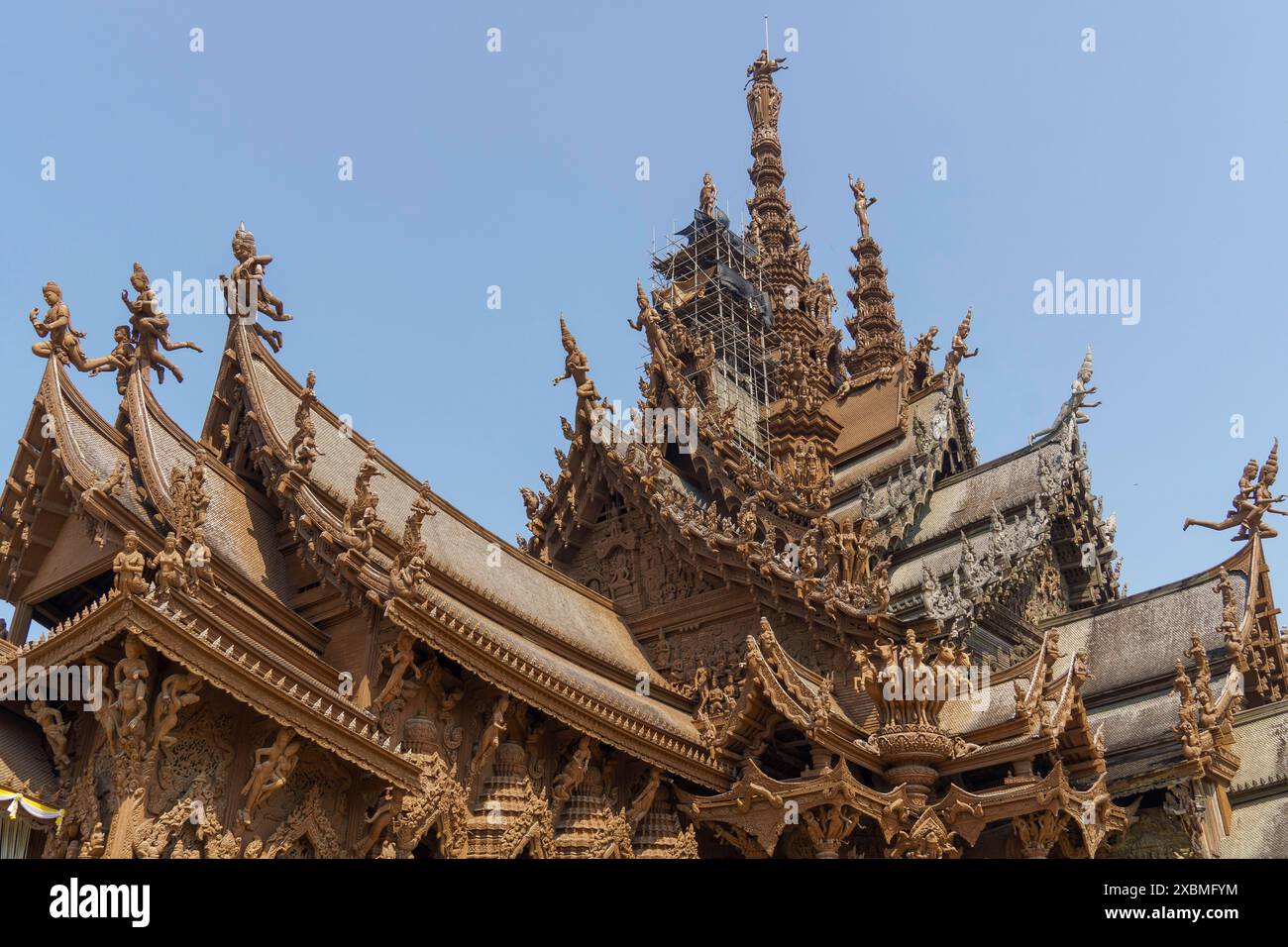An ornate wooden temple with many sculptures and detailed architecture ...