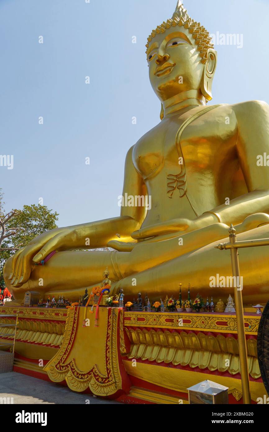 Gigantic golden Buddha statue in lotus position with ornaments on the ...