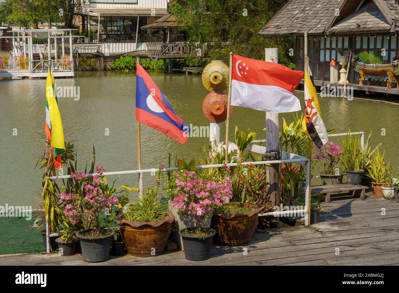 Various national flags and flower pots on the banks of a canal at the ...