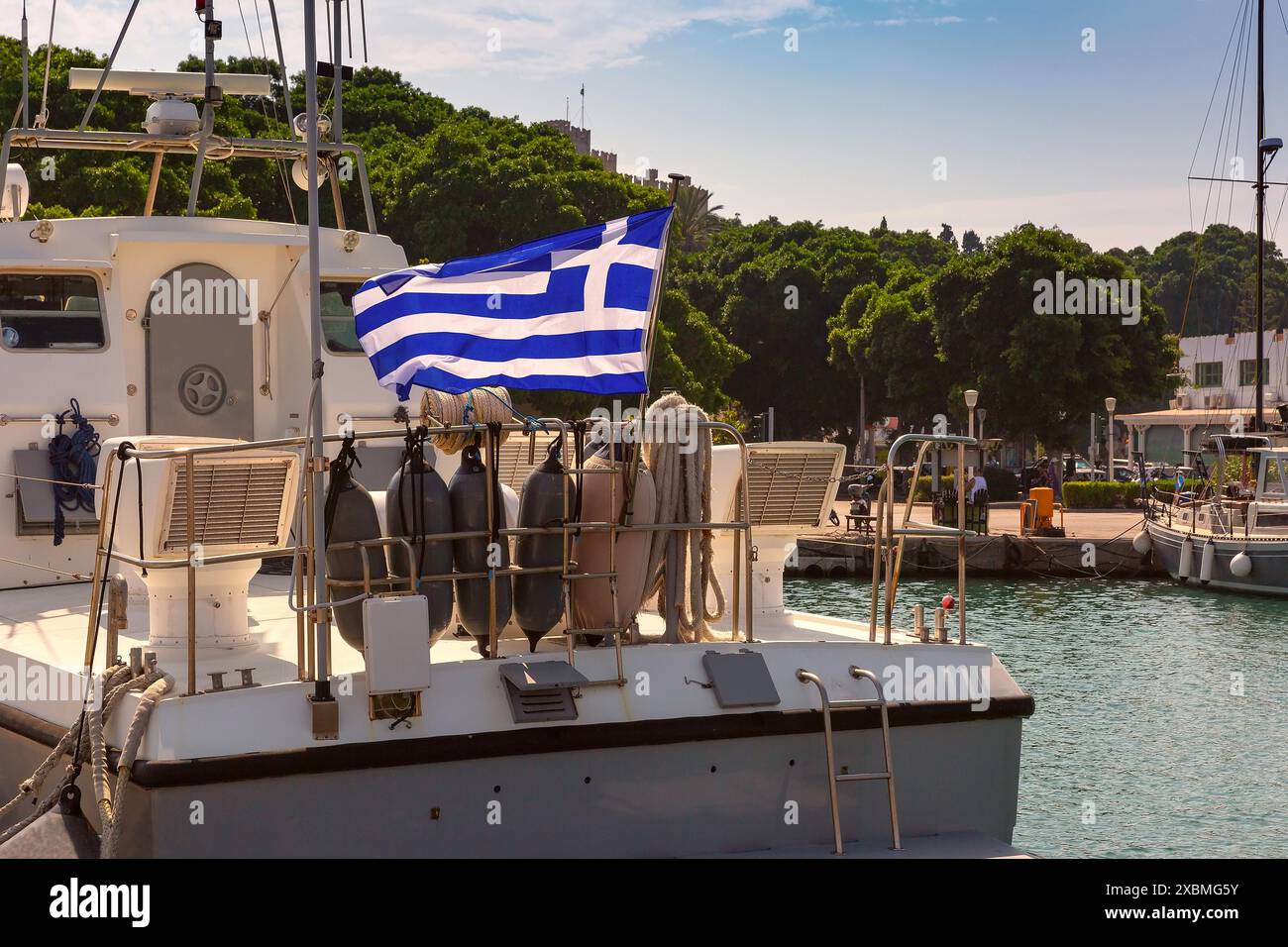 Boats and Greek flags at a marina in Rhodes, Dodecanese islands, Greece ...