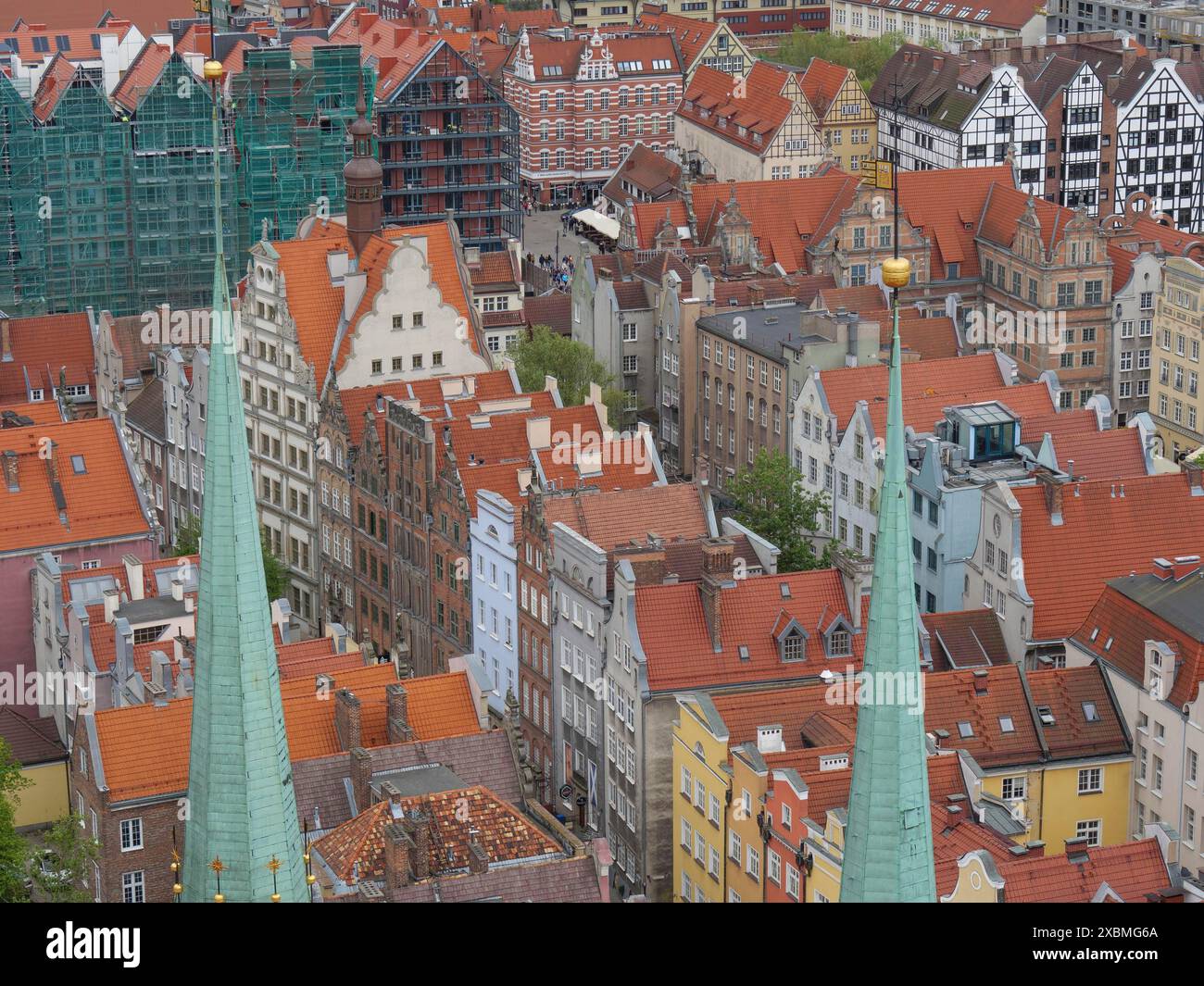 Urban scene with narrow, dense houses and striking church towers with ...