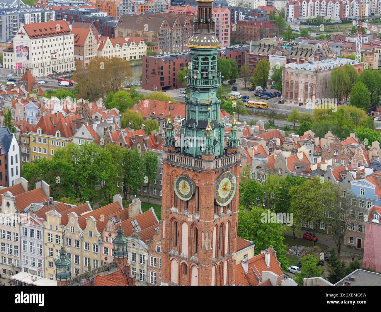 A large clock tower towers over a city with many historic buildings and ...