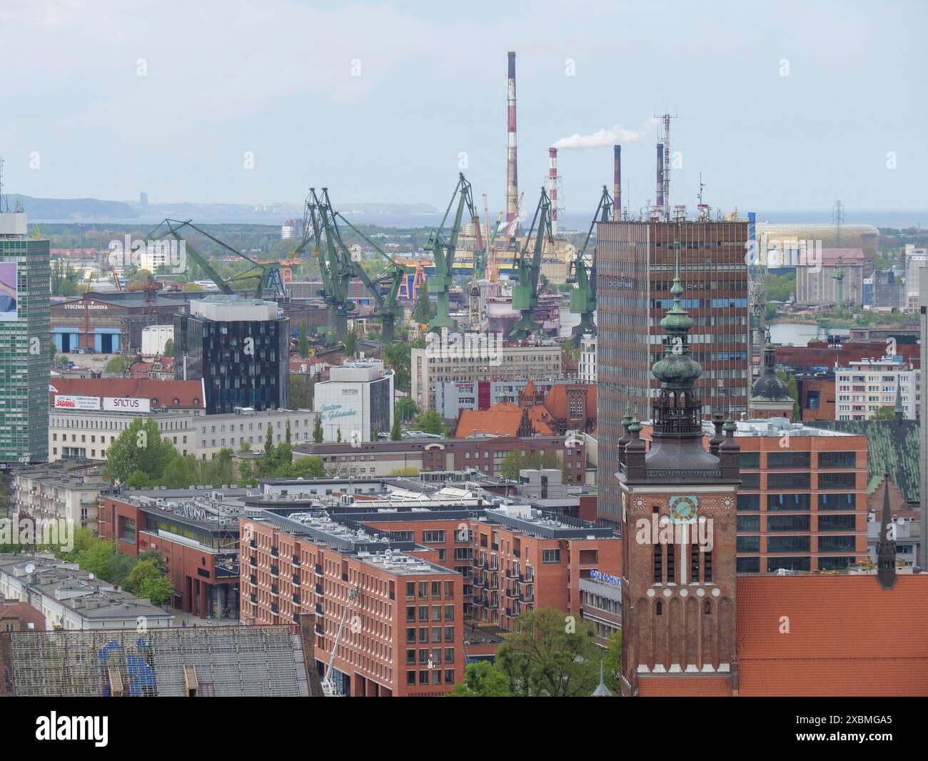 City view with modern buildings, a high tower and cranes in the ...