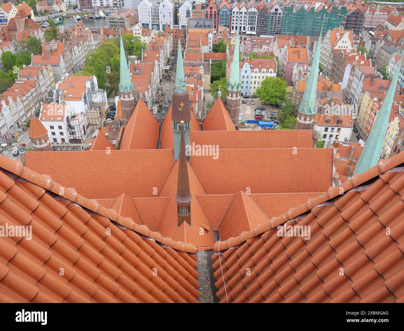 View from a red tiled roof of the city and several church towers rising ...