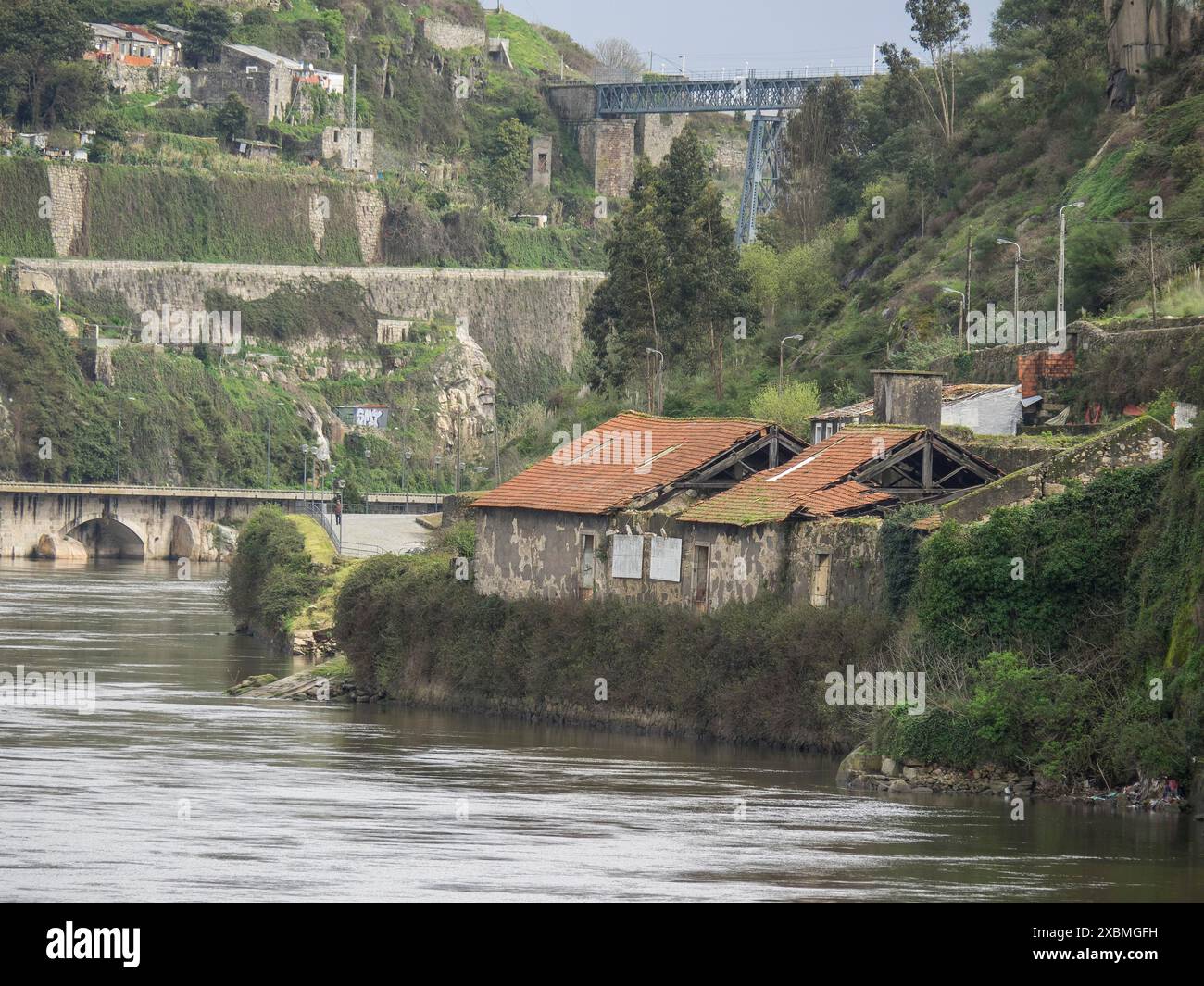 River landscape with scattered buildings, bridges and overgrown ...