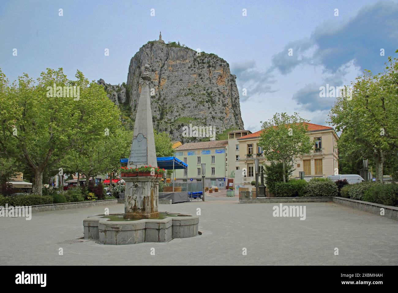 Fountain at Place Marcel Sauvaire with rock Le Roc, cliff, mountain ...